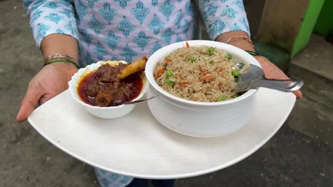 Fried rice with mutton nalli curry at a ... | Stock Video | Pond5