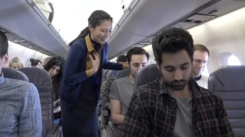 Friendly flight attendant talking with p... | Stock Video | Pond5