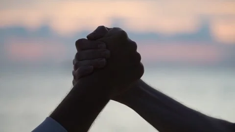 Friendly handshake of two men on backgro... | Stock Video | Pond5