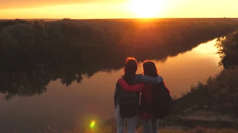 Friends with backpacks hug at dawn. Beau... | Stock Video | Pond5