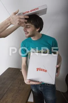 Friends balancing a pizza box on head Stock Image #25125001