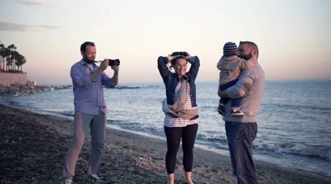 Friends on beach, man filming happy fami... | Stock Video | Pond5