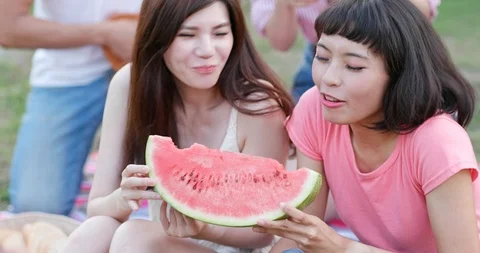 Friends eating watermelon in the park | Stock Video | Pond5
