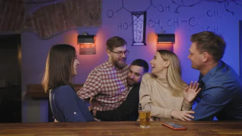 Friends meet in pub at bar counter. Peop... | Stock Video | Pond5