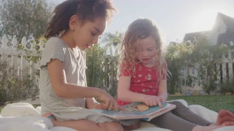 Friends Pointing At Pictures In Book | Stock Video | Pond5