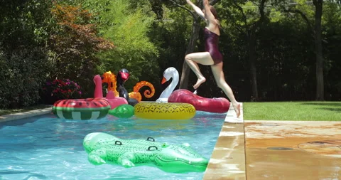 Friends running and jumping into swimmin... | Stock Video | Pond5