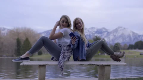 Friends Sit Back To Back, Teen Shows Her... | Stock Video | Pond5