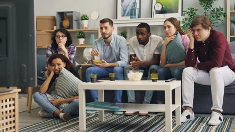 Friends watching sad movie on TV crying ... | Stock Video | Pond5