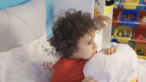 The frightened boy in the bed was distur... | Stock Video | Pond5