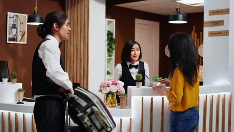 Front desk staff giving key card and pas... | Stock Video | Pond5