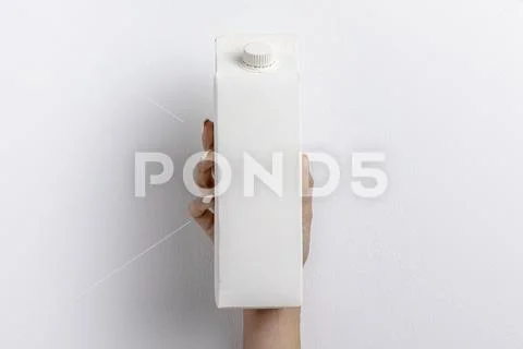 Front view hand holding simple milk carton Stock Photo #252180250