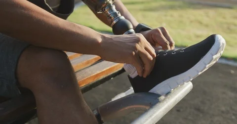 Front view man with prosthetic leg tying... | Stock Video | Pond5