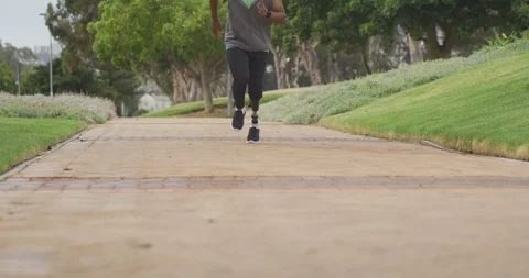 Front view man with prosthetic leg runni... | Stock Video | Pond5