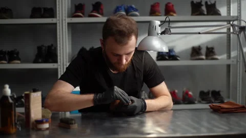 Front view of shoemaker wearing black la... | Stock Video | Pond5