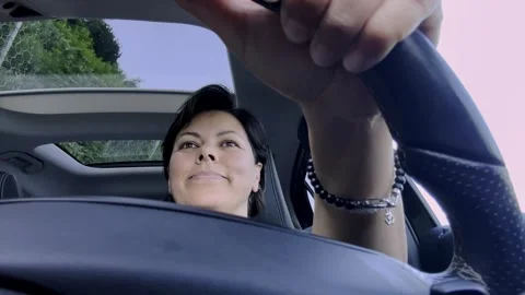 Front View of a Smiling Woman Driving a ... | Stock Video | Pond5