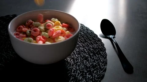 Froot loops cereal being poured into bow... | Stock Video | Pond5
