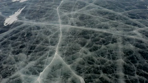 Frozen ice with cracks and very clear wa... | Stock Video | Pond5