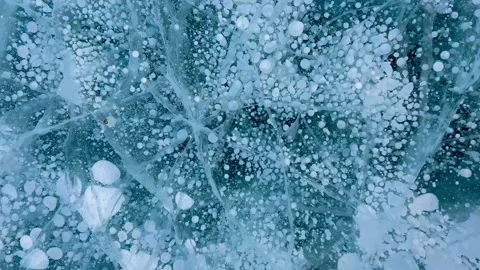 Frozen methane bubbles and cracks in the... | Stock Video | Pond5