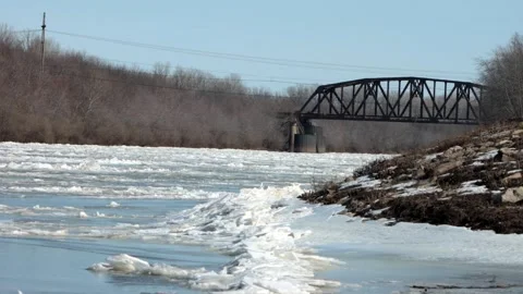 Frozen River with bridge in background -... | Stock Video | Pond5