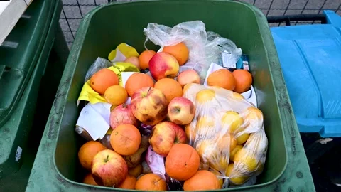 Fruit thrown in the trash can. Food wast... | Stock Video | Pond5