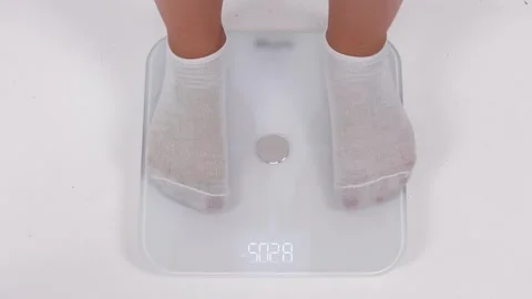 Full-figured woman standing on a scale d... | Stock Video | Pond5