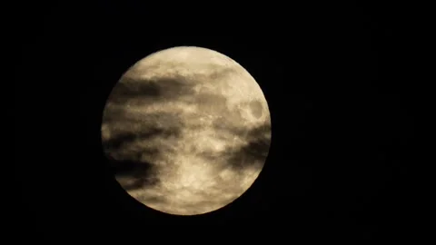 The full moon crosses the night sky behi... | Stock Video | Pond5