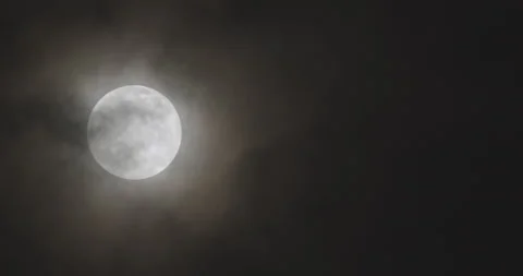 Full moon at midnight with cloudy sky | Stock Video | Pond5