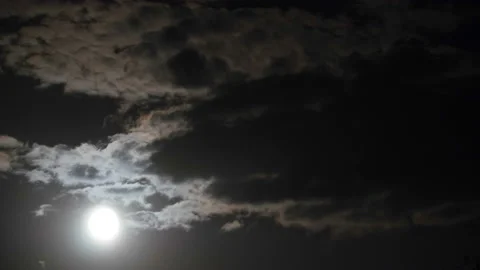 Full Moon Moves in the Night Sky through... | Stock Video | Pond5