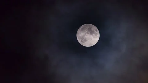 Full moon moving through dark clouds at ... | Stock Video | Pond5