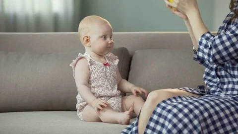 Funny active baby girl playing with moth... | Stock Video | Pond5