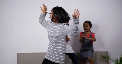 Funny asian kids dancing on sofa in livi... | Stock Video | Pond5