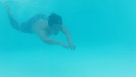 funny asian man swimming underwater in p... | Stock Video | Pond5