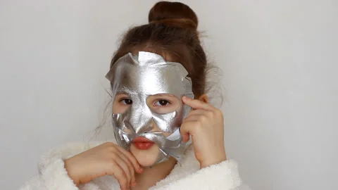 Funny baby girl wearing silver mask in s... | Stock Video | Pond5