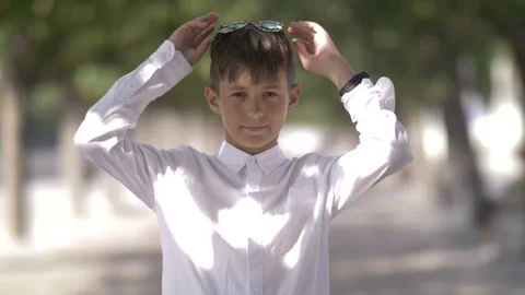 funny boy looks into the camera puts on ... | Stock Video | Pond5