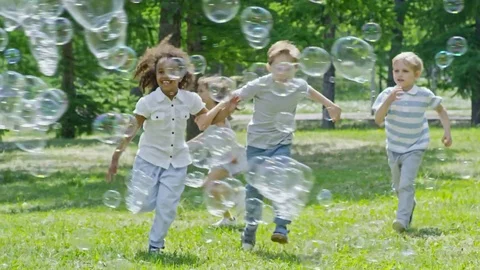 Funny Kids Running and Playing with Bubb... | Stock Video | Pond5