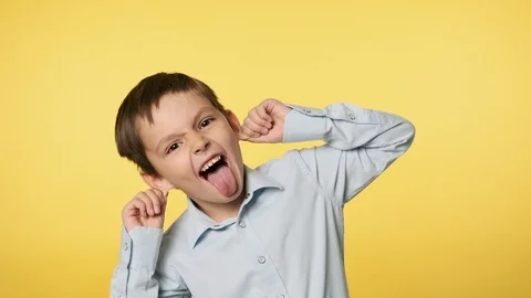 Funny little boy making silly faces. Boy... | Stock Video | Pond5