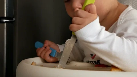 Funny Little Boy Trying to Stab Food Rus... | Stock Video | Pond5