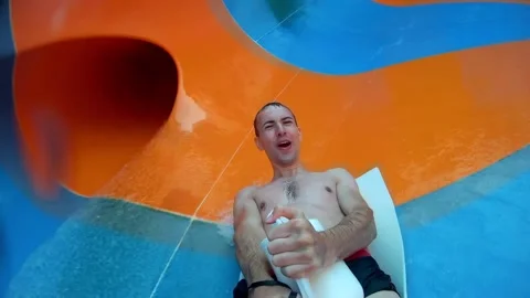 Funny ride on water slide pool in aqua p... | Stock Video | Pond5