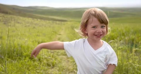 Funny smiling little boy running in gras... | Stock Video | Pond5