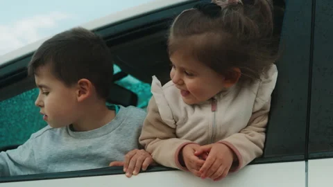 Funny young kids sticking their heads an... | Stock Video | Pond5