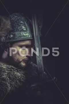 Photograph: Furious, Costume, Viking warrior with a huge sword and ...