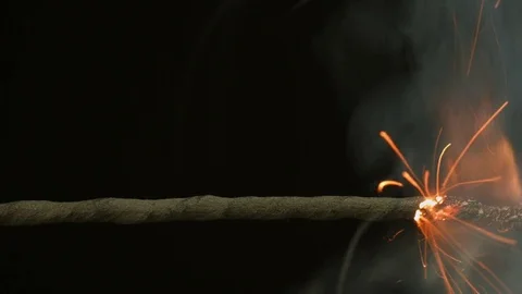 Fuse lights up on a black background. | Stock Video | Pond5