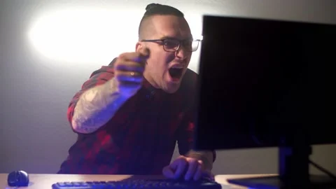 Gamer yelling at a computer and types on... | Stock Video | Pond5