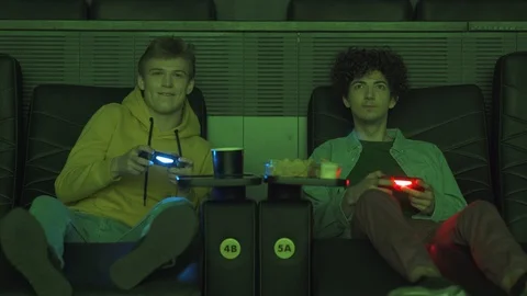 Gamers playing in a movie theater, two f... | Stock Video | Pond5