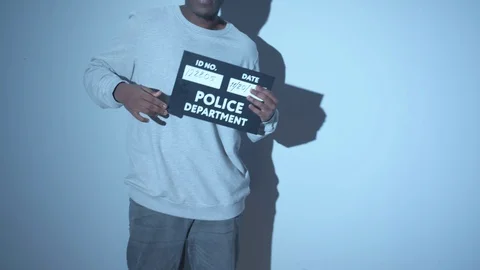 Gangster poses for a photo at the police... | Stock Video | Pond5