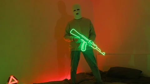 A gangster in a white mask holds a neon ... | Stock Video | Pond5