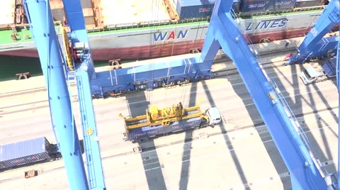 A gantry crane picking up a container of... | Stock Video | Pond5
