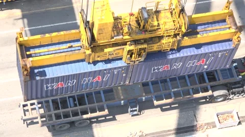 A gantry crane picking up a container of... | Stock Video | Pond5