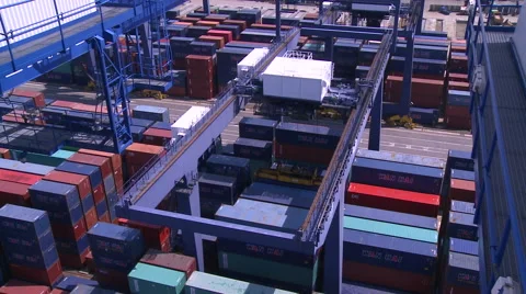 A gantry crane is stacking containers in... | Stock Video | Pond5