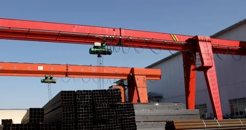 Gantry crane transporting stack of metal... | Stock Video | Pond5